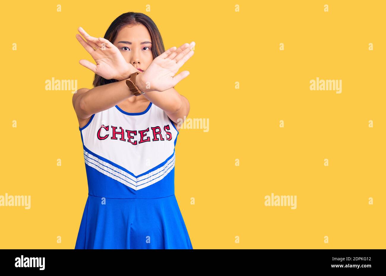 Young beautiful chinese girl wearing cheerleader uniform rejection ...