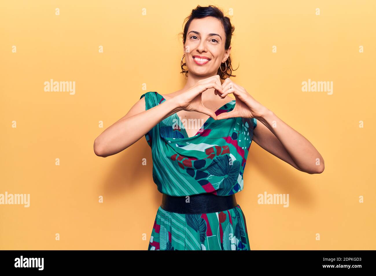 Young beautiful hispanic woman wearing casual dress smiling in love ...