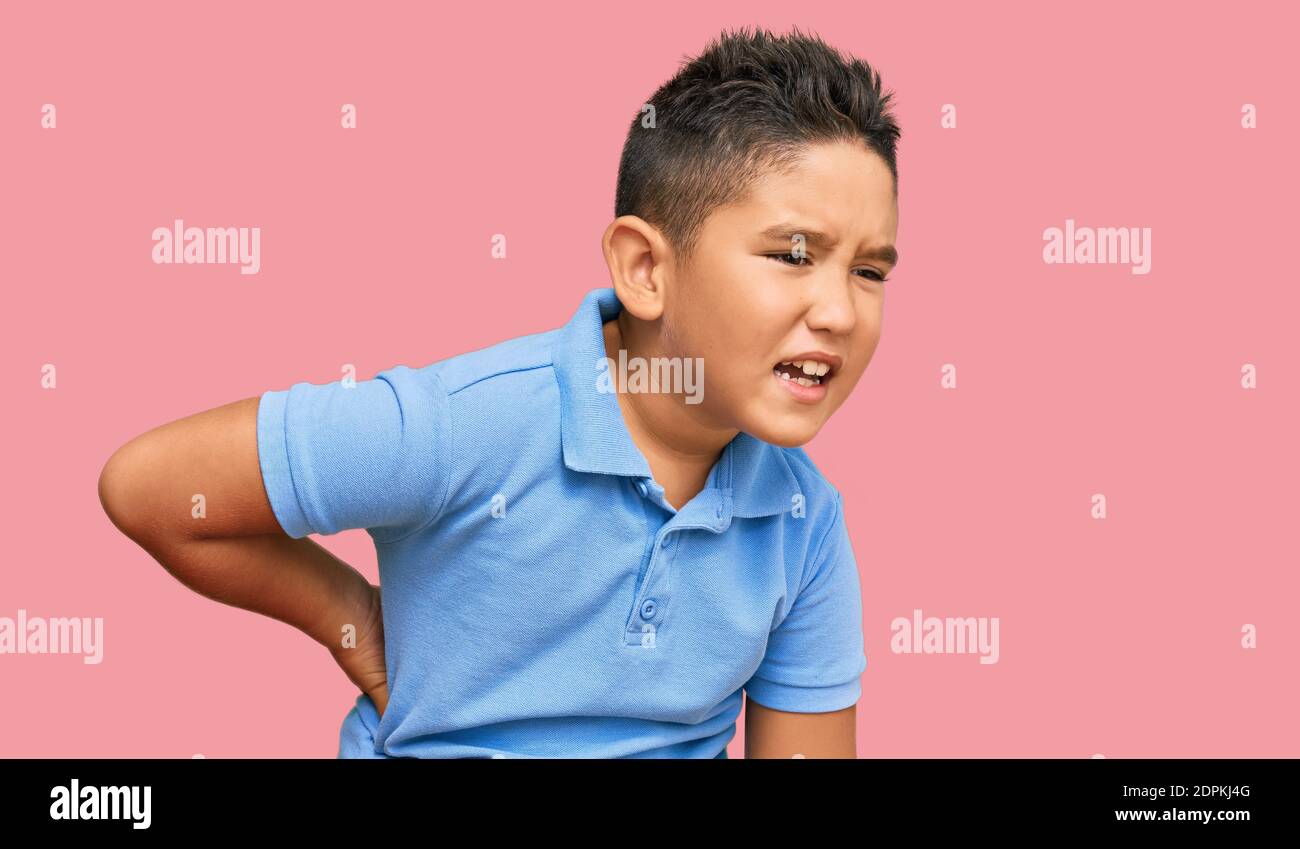 Little boy hispanic kid wearing casual clothes suffering of backache ...
