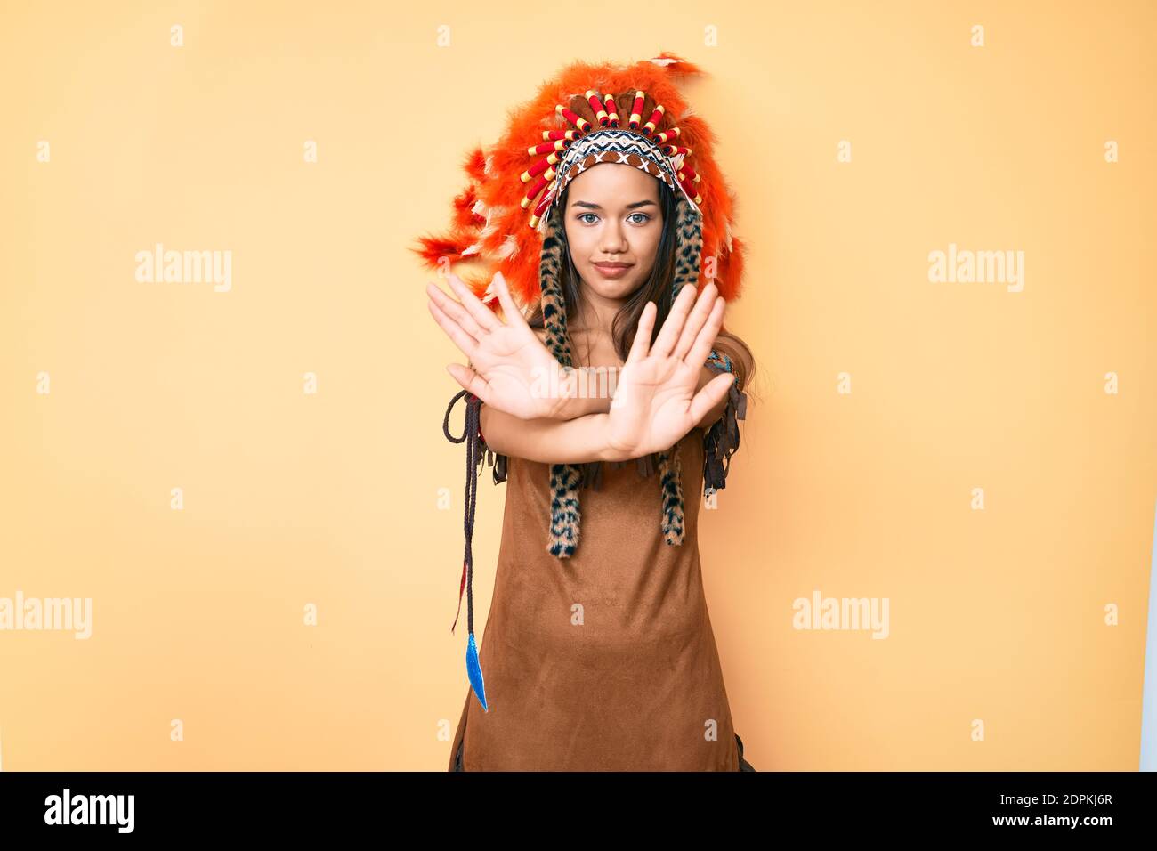 Young beautiful latin girl wearing indian costume rejection expression ...