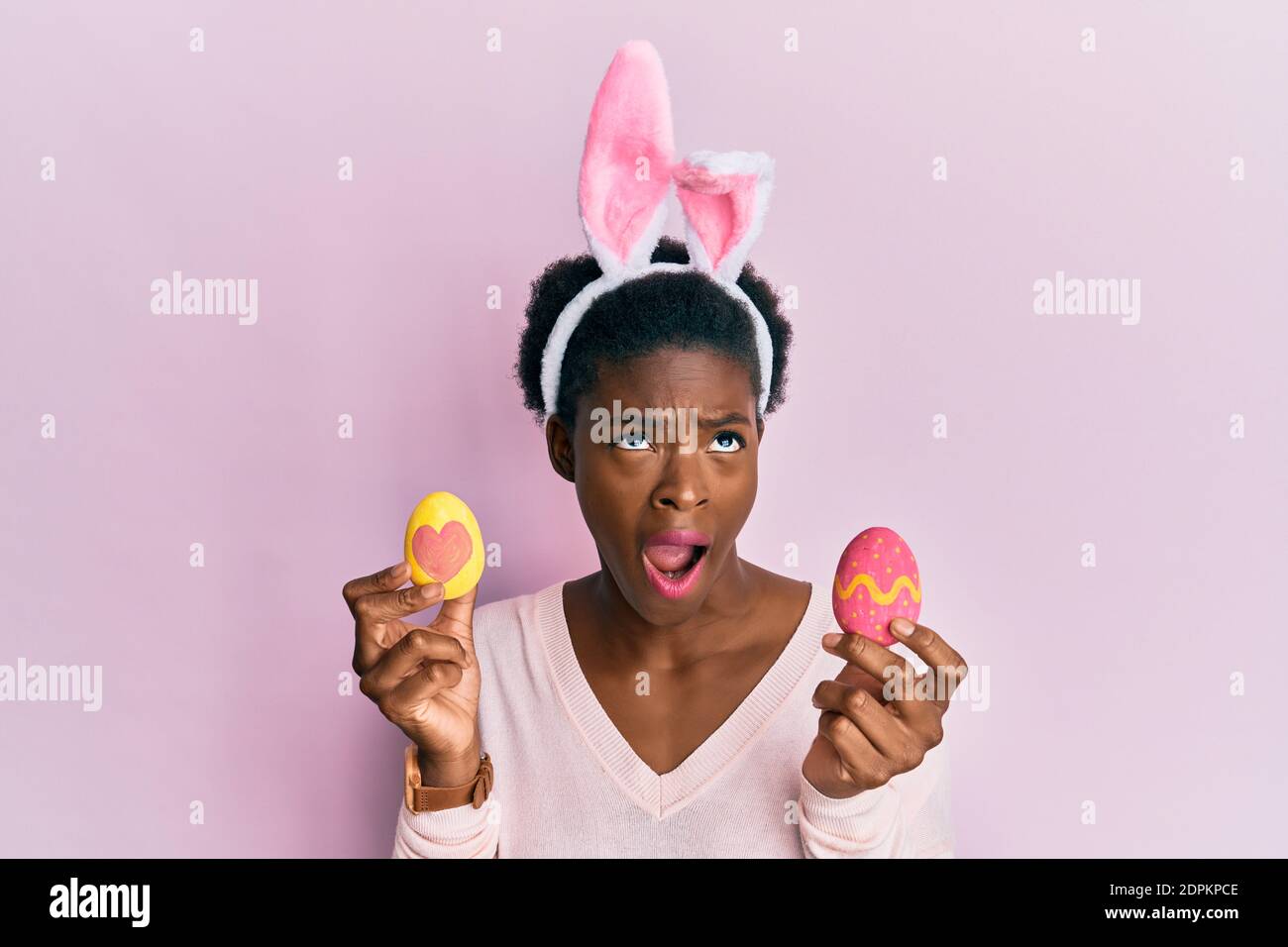 Young african american girl wearing cute easter bunny ears holding ...