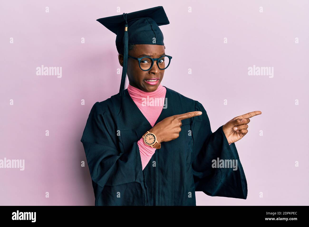 Young african american girl wearing graduation cap and ceremony robe ...