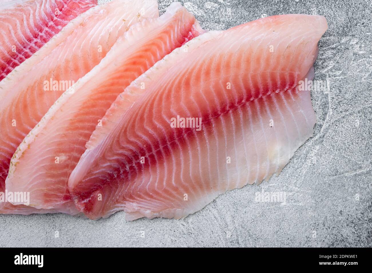 Raw white fish fillet cuts, on gray background Stock Photo - Alamy