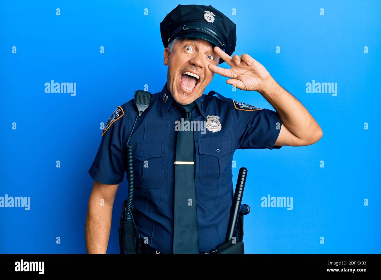 Handsome middle age mature man wearing police uniform doing peace ...