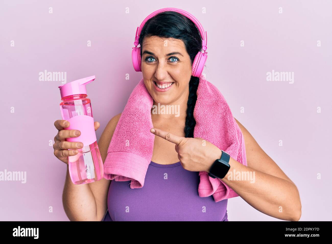 Plus Size Brunette Woman Wearing Sportswear Holding Water Bottle