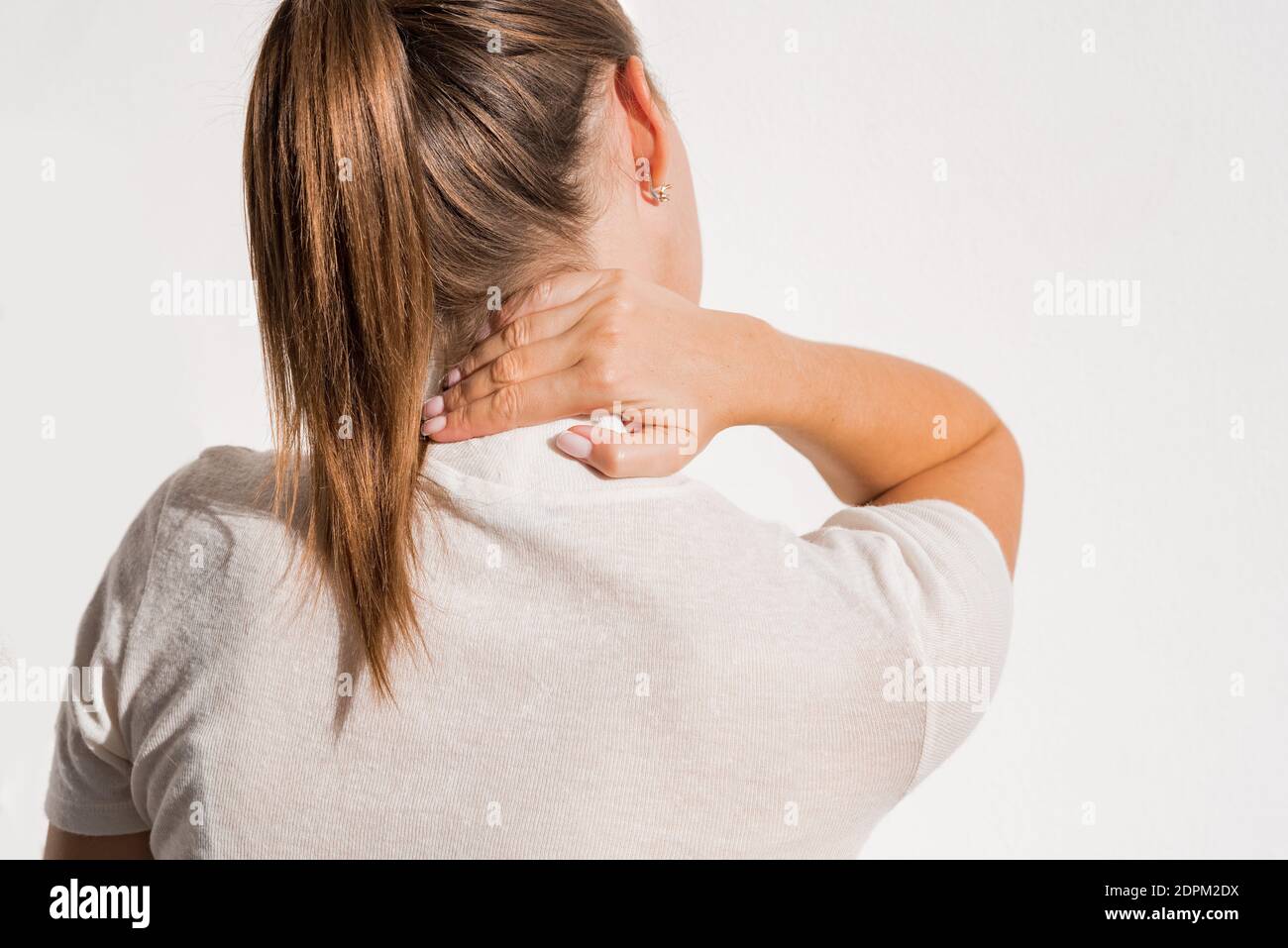 Woman suffering from neck pain or injury. Female massaging her neck ...