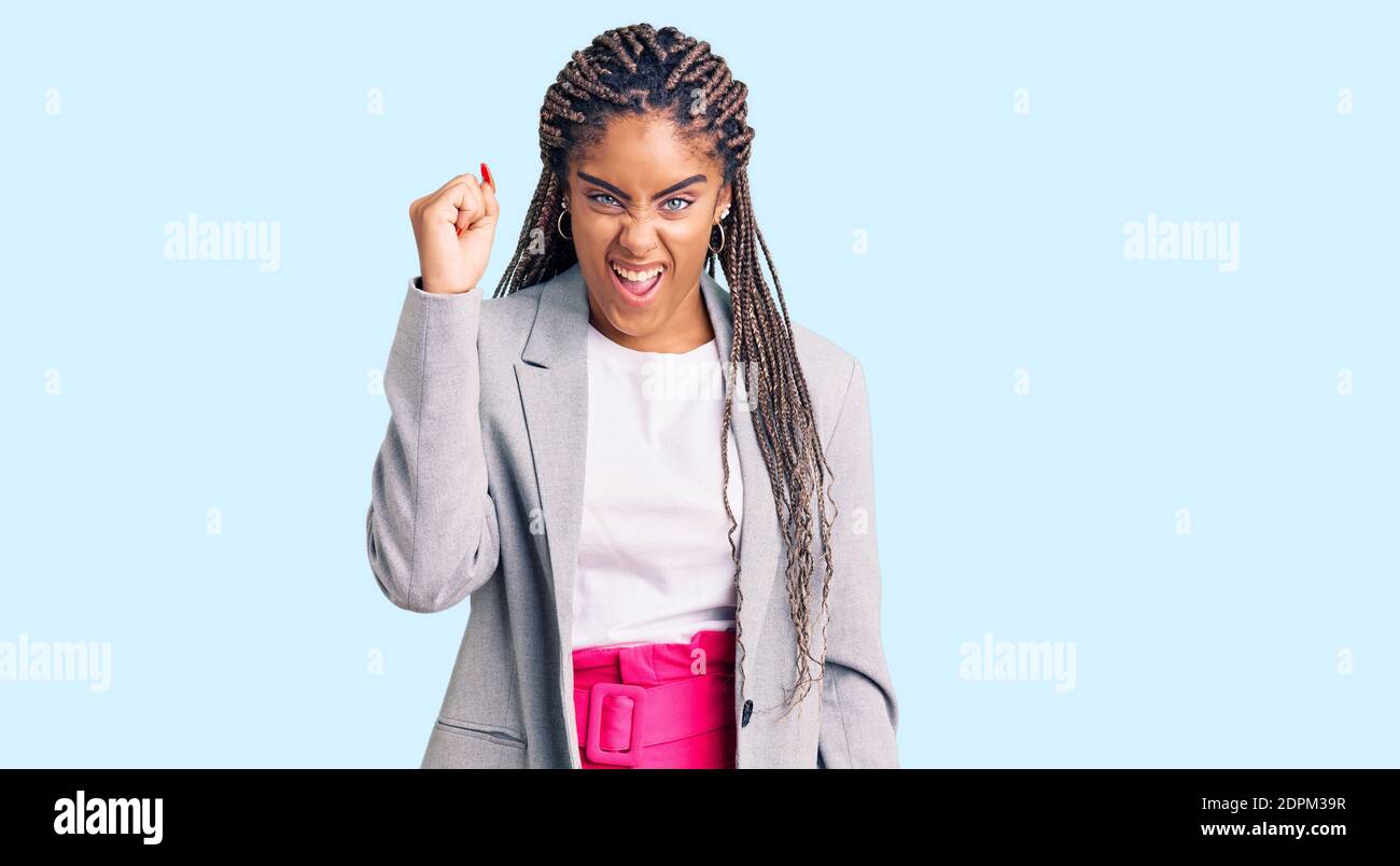 Young african american woman with braids wearing business clothes angry ...