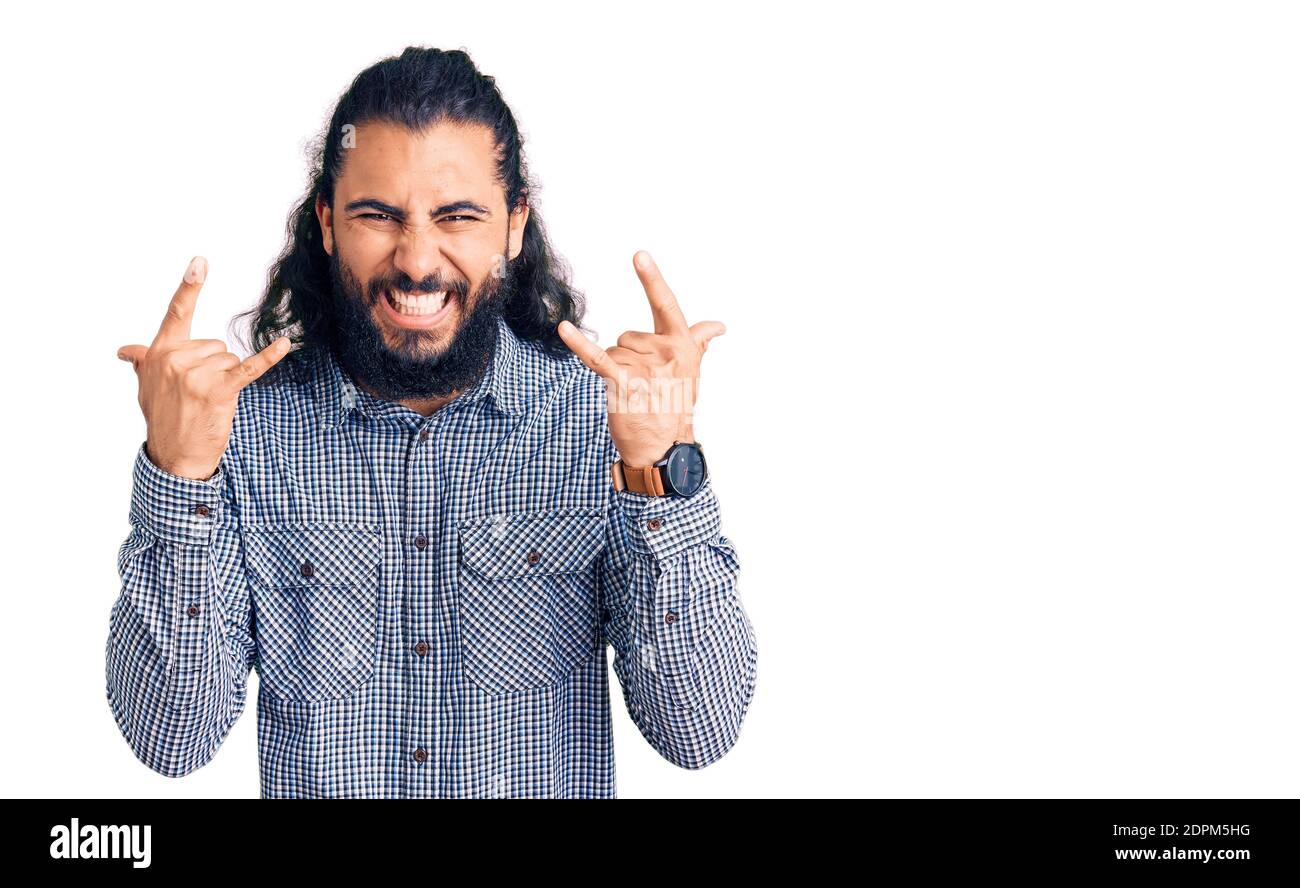 Young arab man wearing casual clothes shouting with crazy expression ...