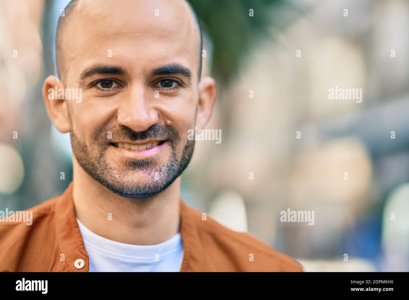 Young hispanic bald man smiling happy standing at the city Stock Photo ...