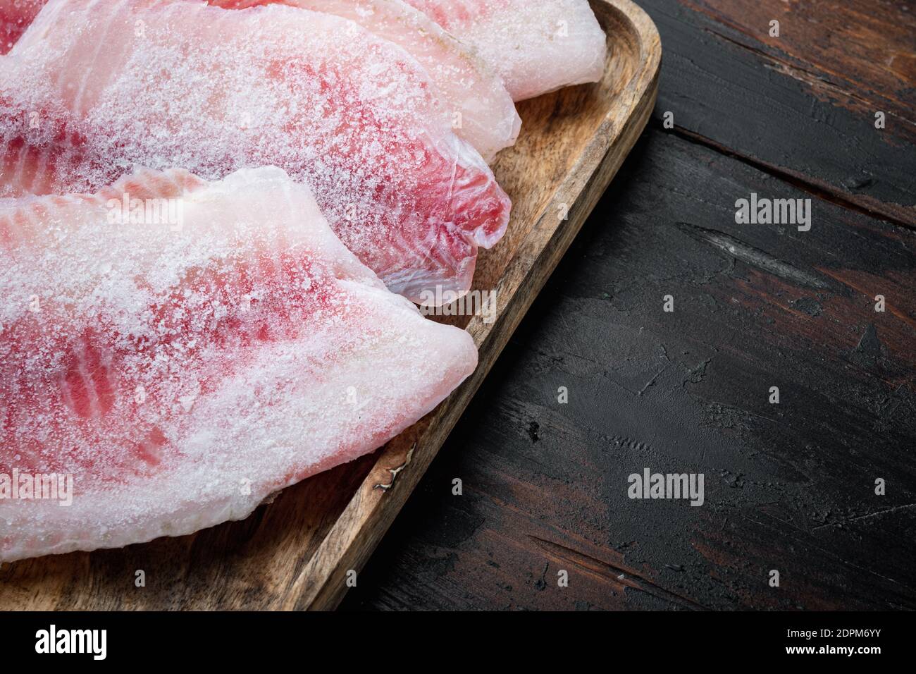 Frozen fish fillet set, on old wooden table, top view with copy space ...