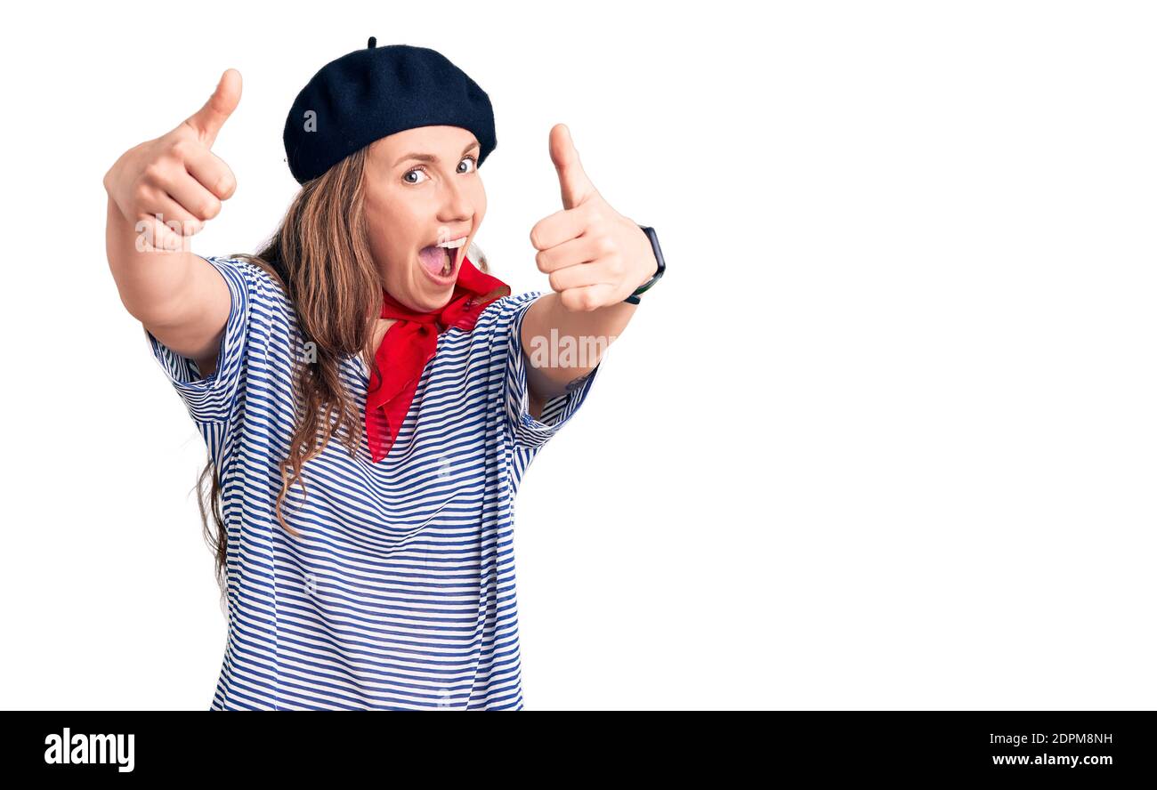 Young beautiful blonde woman wearing french beret and striped t-shirt ...