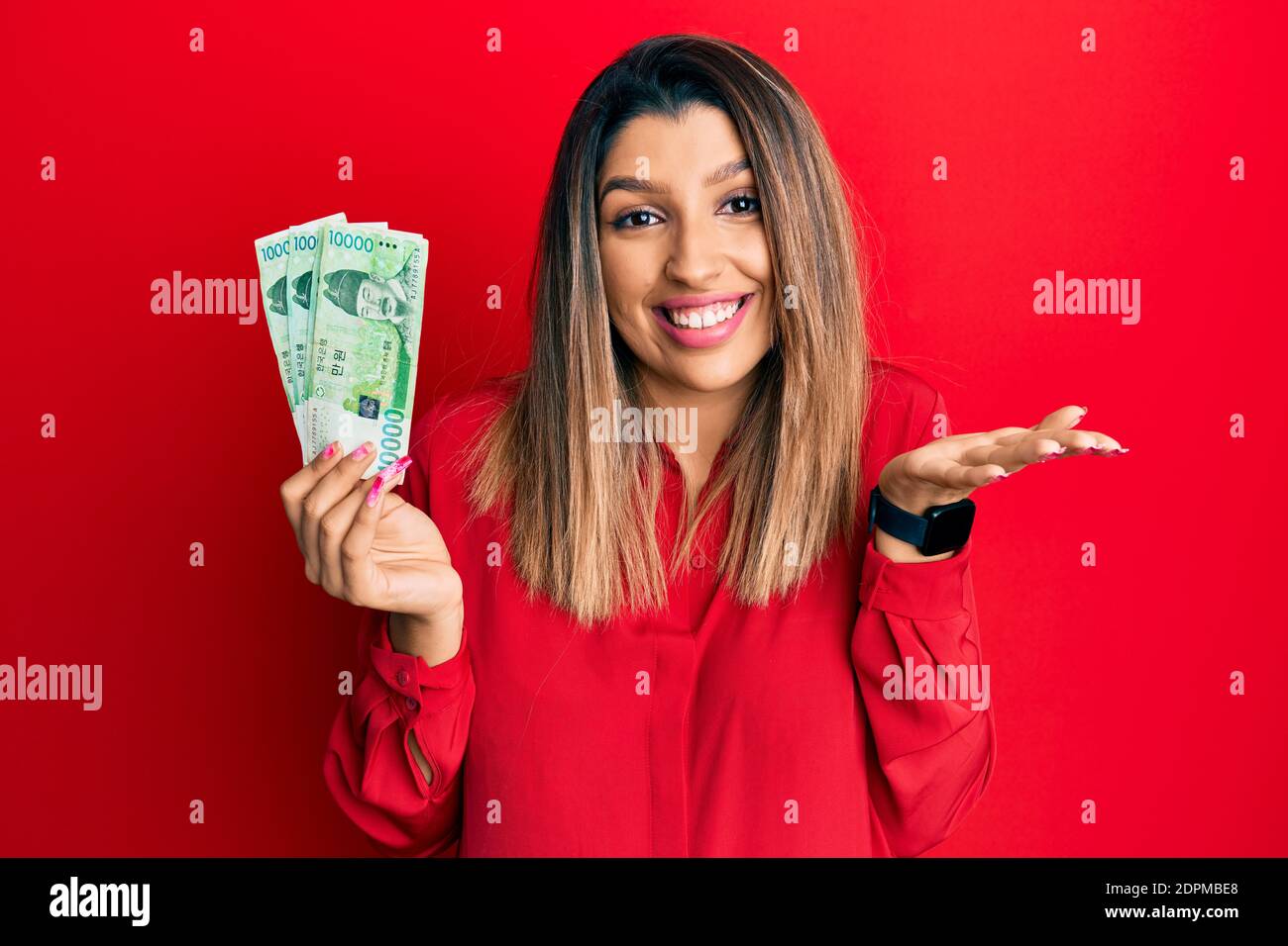 Beautiful brunette woman holding 10000 south korean won banknotes ...
