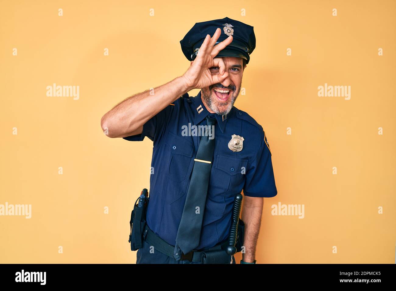 Middle age hispanic man wearing police uniform doing ok gesture with ...