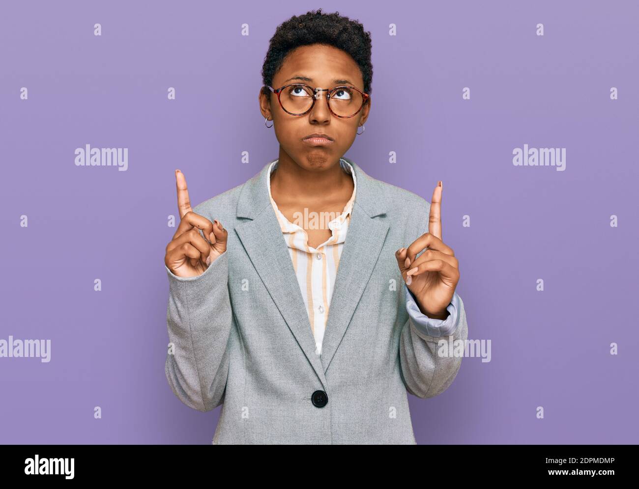 Young african american woman wearing business clothes pointing up ...