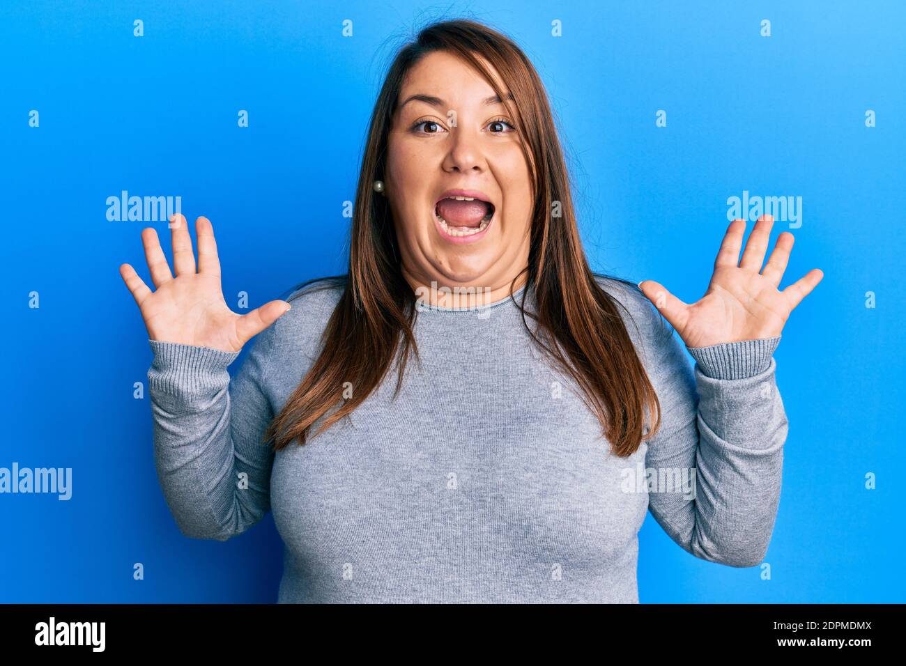 Beautiful brunette plus size woman wearing casual clothes celebrating ...