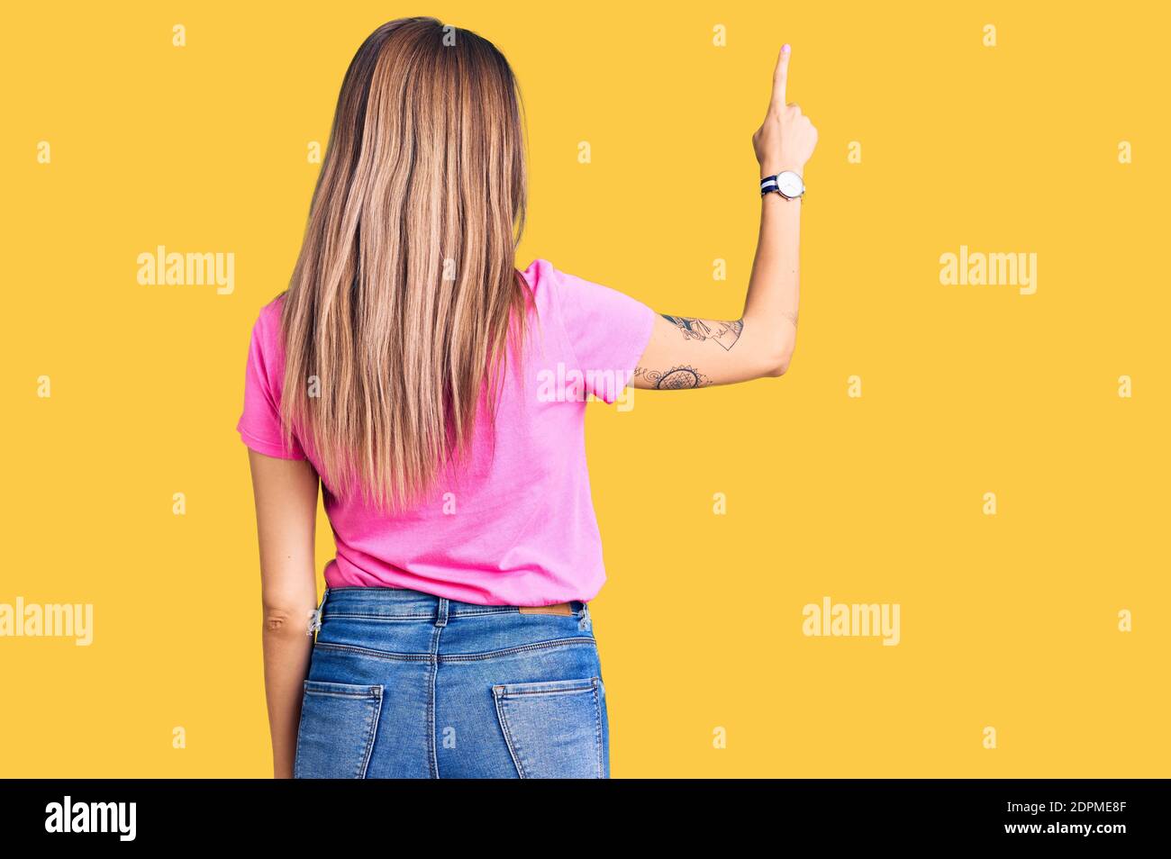 Beautiful caucasian woman wearing casual clothes posing backwards ...