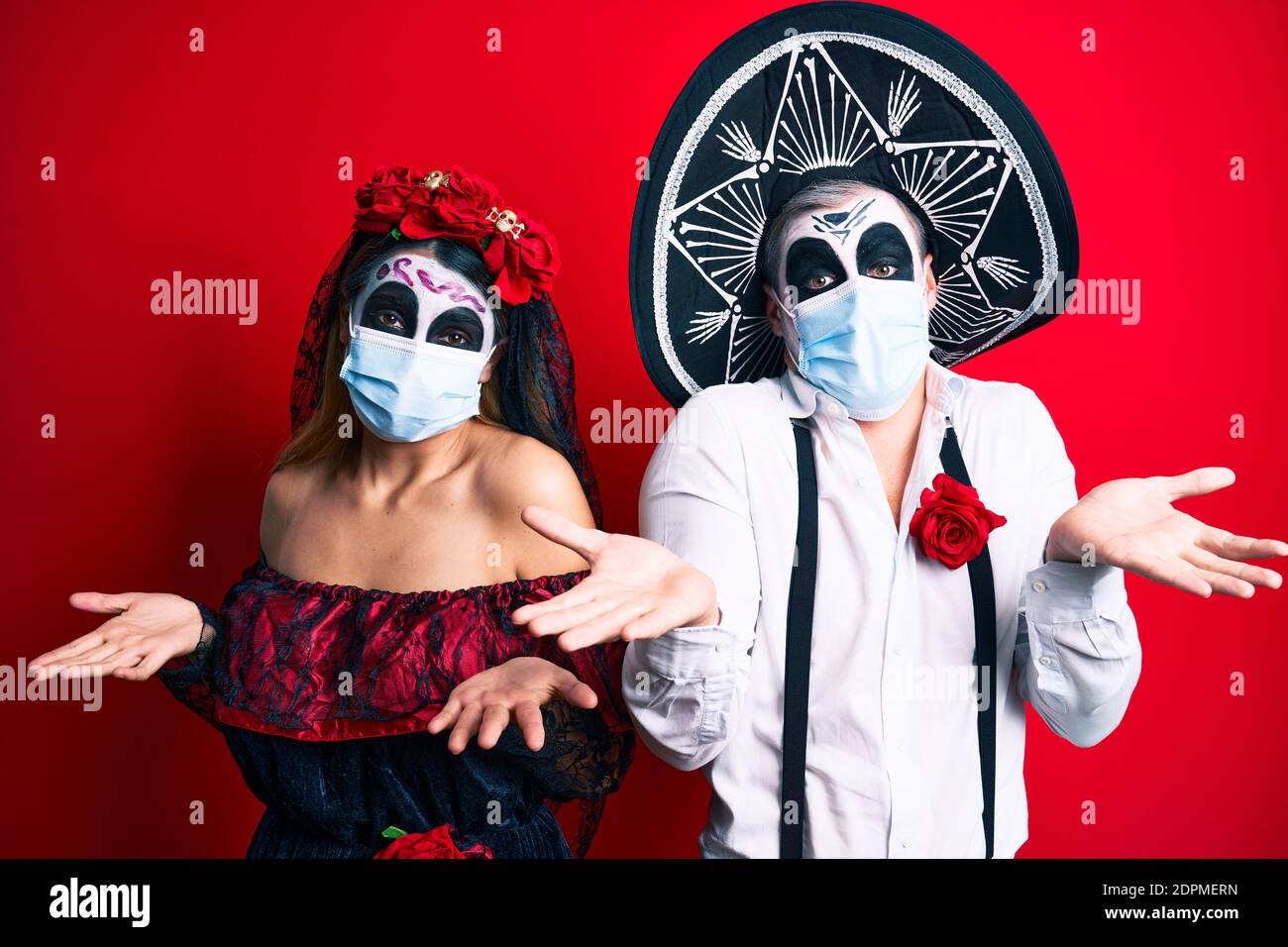 Couple wearing day of the dead costume wearing medical mask clueless ...