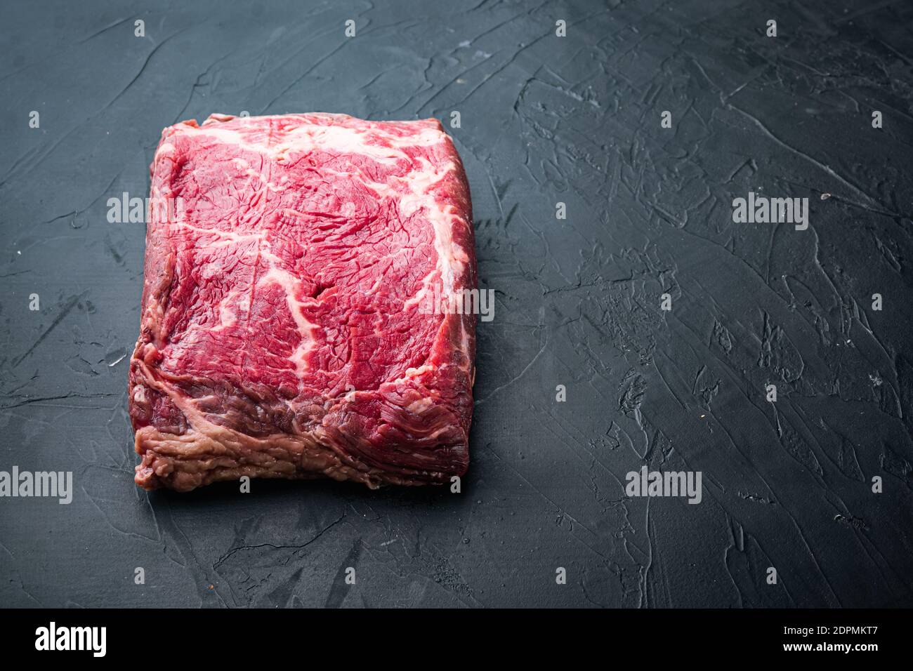 Striploin steak raw beef butchery cut, on black background, with copy ...