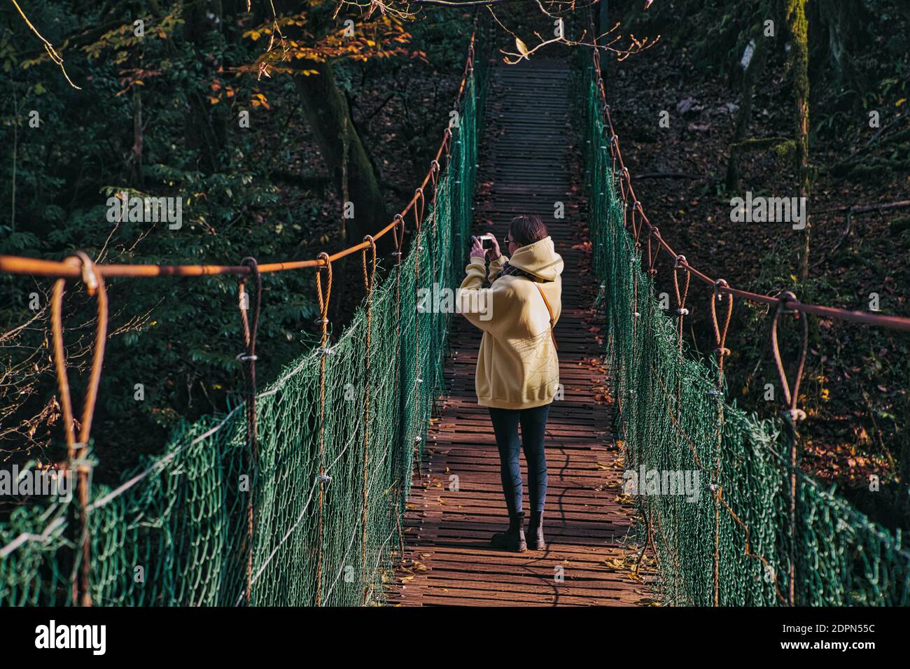 Woman crossing suspension bridge hi-res stock photography and images ...