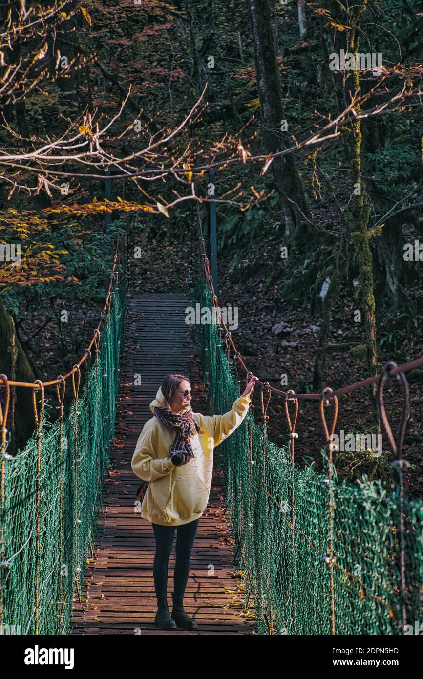 Young woman crossing bridge hi-res stock photography and images - Alamy