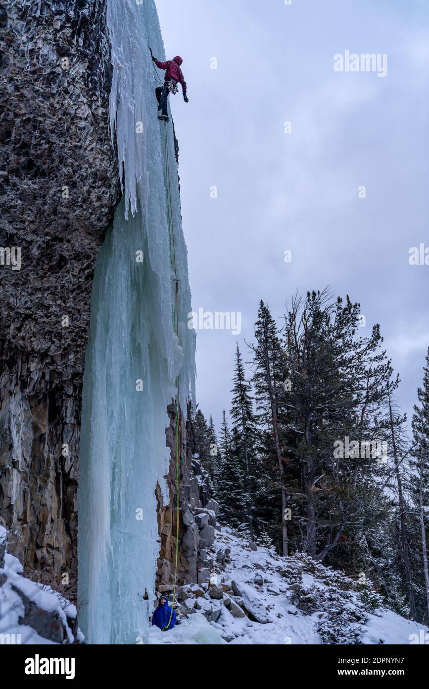 Ice climbers enjoying a day outside climbing frozen waterfalls in ...