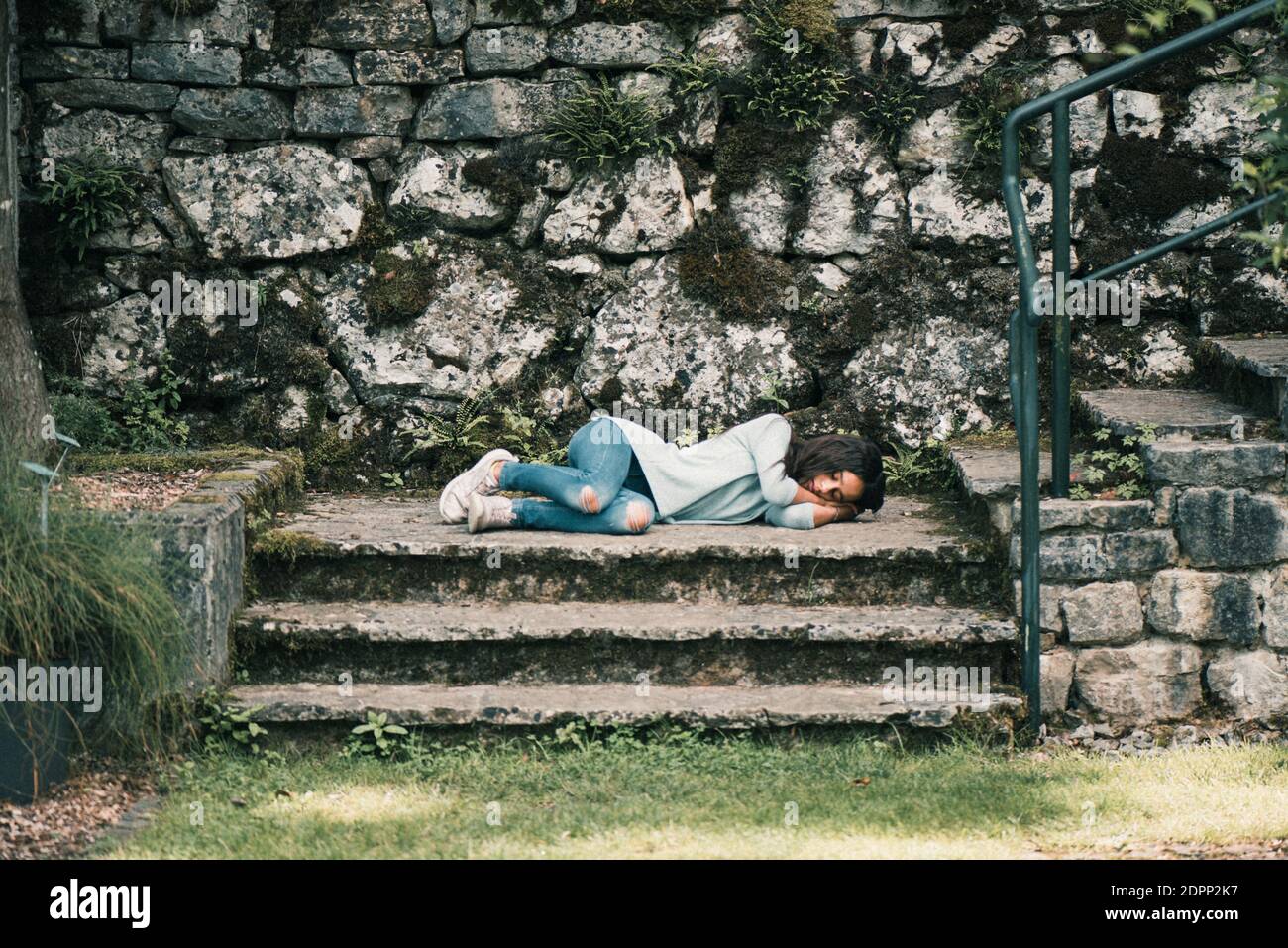 Woman sleeping on stone wall hi-res stock photography and images - Alamy