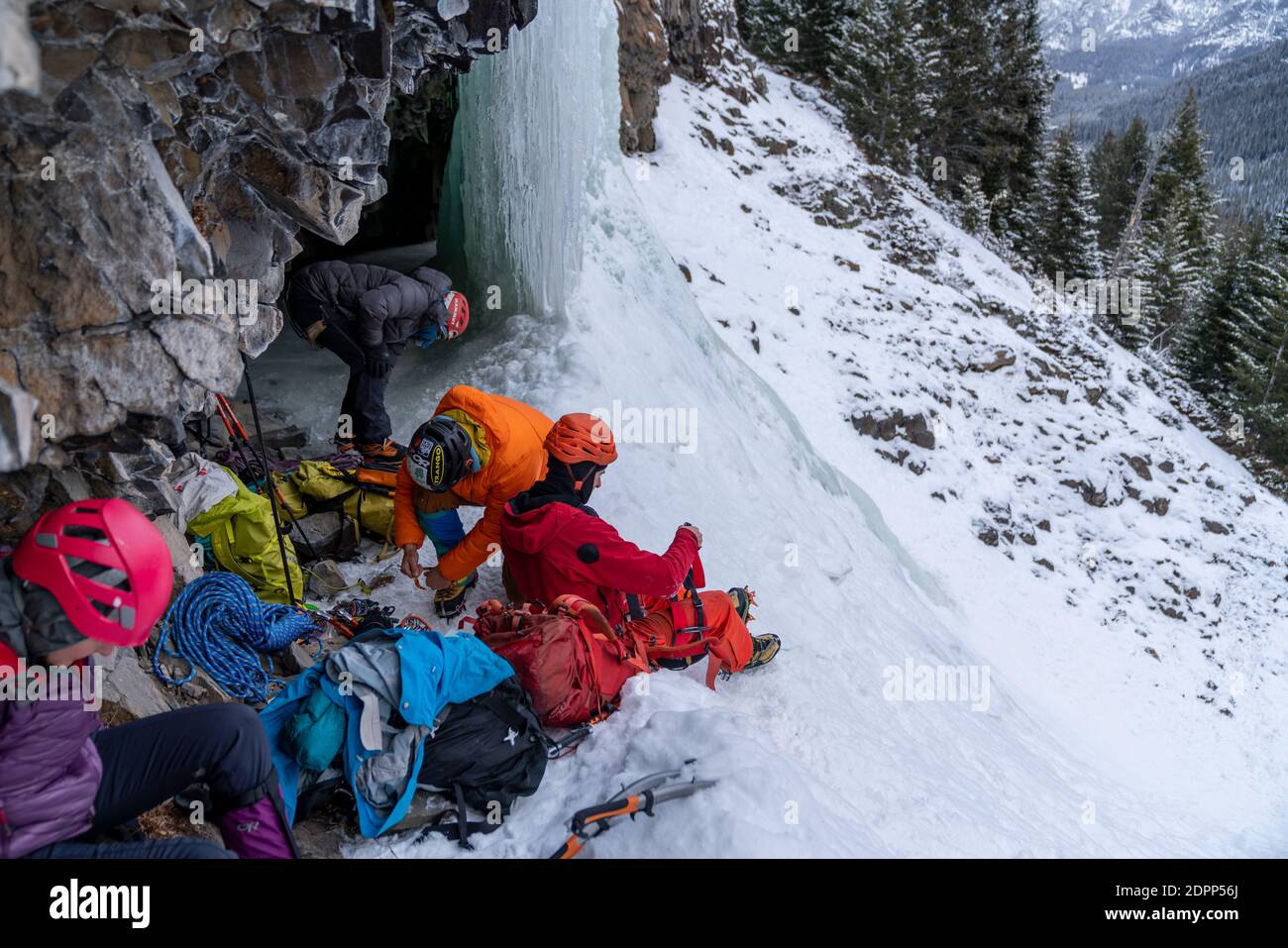 Ice climbers enjoying a day outside climbing frozen waterfalls in ...