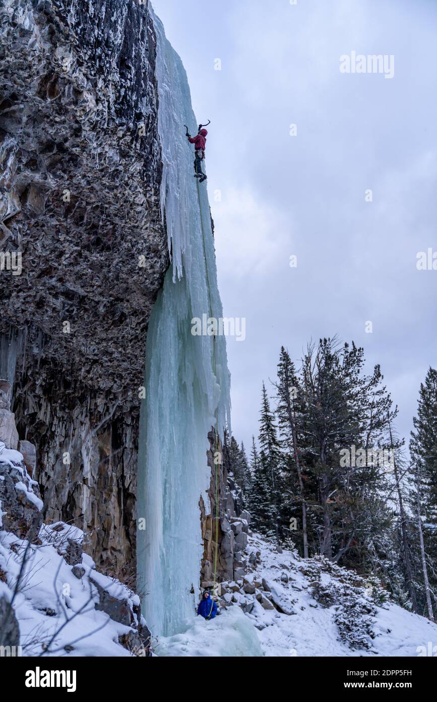 Ice climbers enjoying a day outside climbing frozen waterfalls in ...