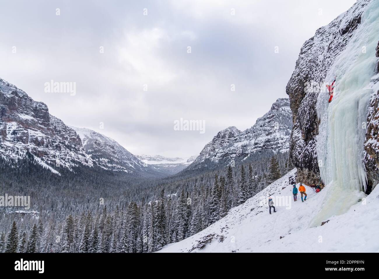 Ice climbers enjoying a day outside climbing frozen waterfalls in ...