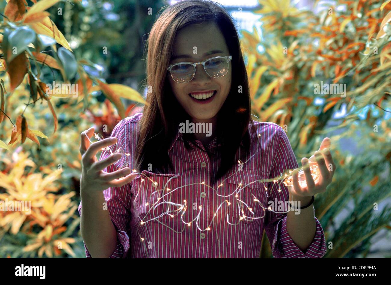 Woman standing happy fairy lights hi-res stock photography and images ...