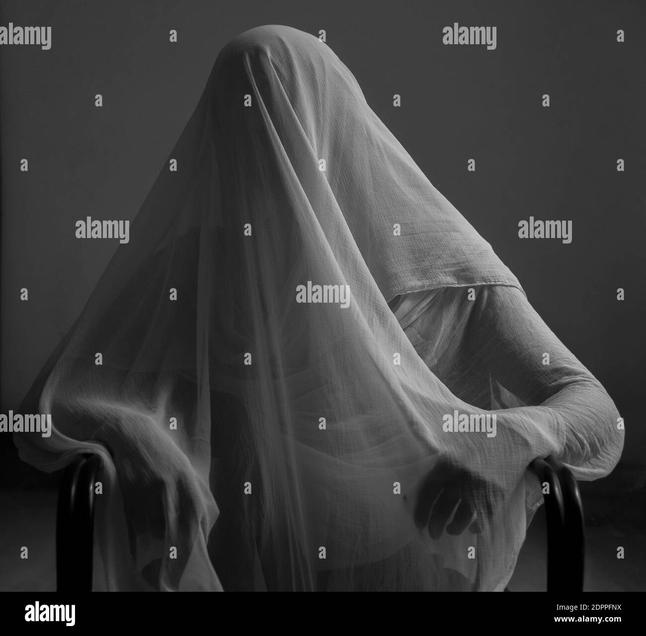 Person Covered With Fabric Sitting On Chair Stock Photo - Alamy