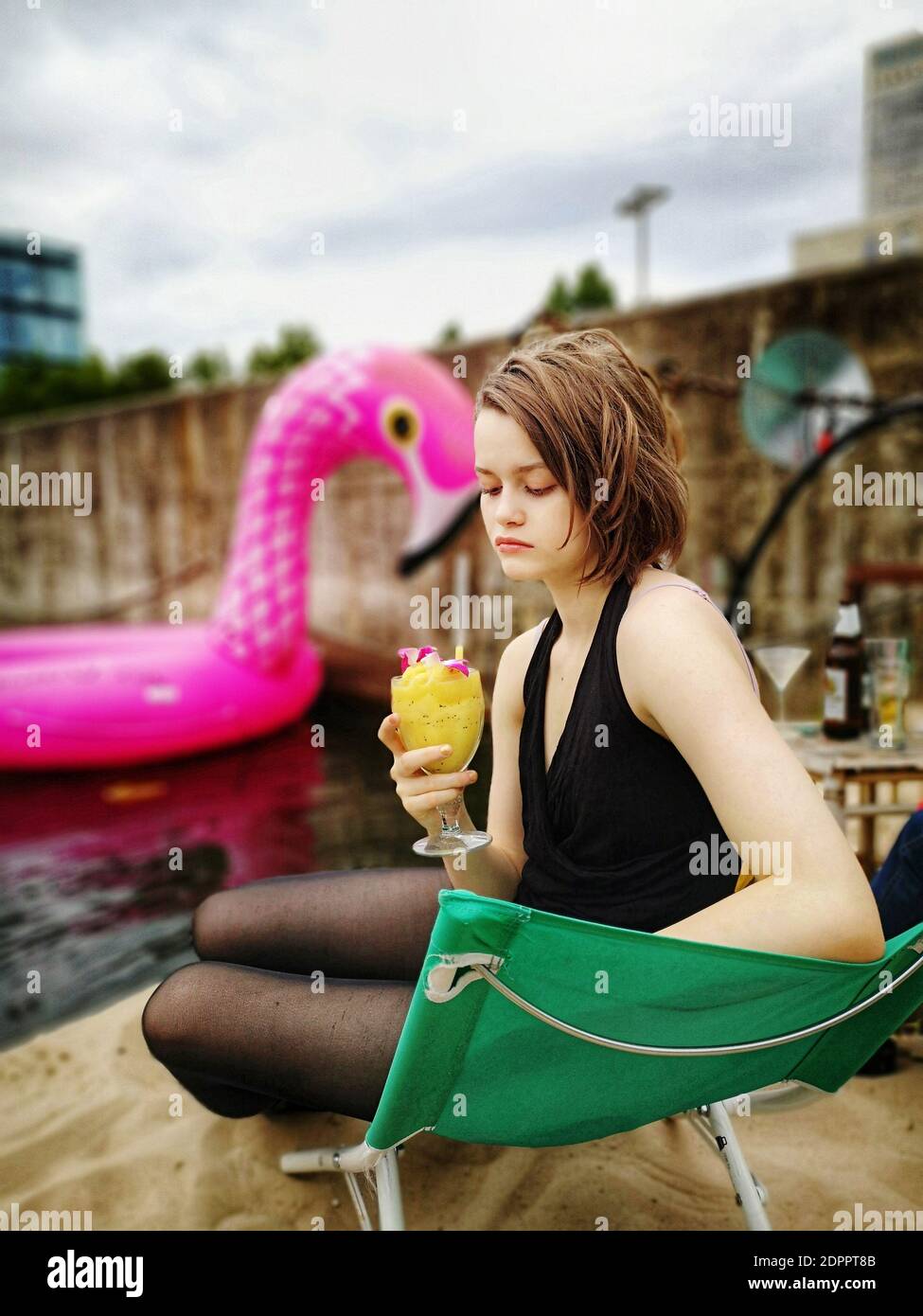 Sad Girl Holding Ice Cream While Sitting By Swimming Pool Stock Photo ...