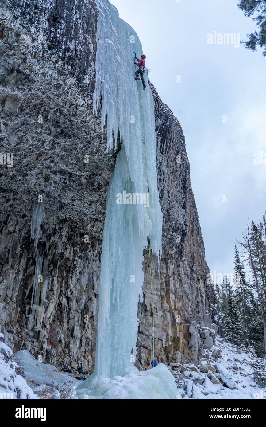 Ice climbers enjoying a day outside climbing frozen waterfalls in ...
