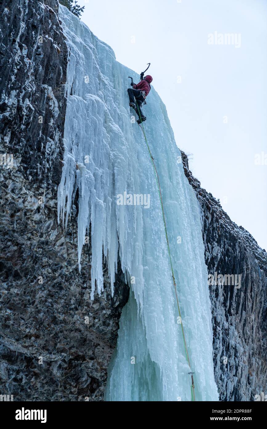 Ice climbers enjoying a day outside climbing frozen waterfalls in ...