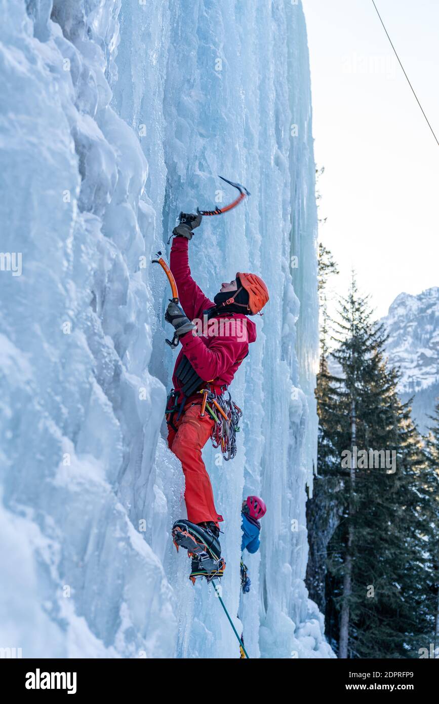 Ice climbers enjoying a day outside climbing frozen waterfalls in ...