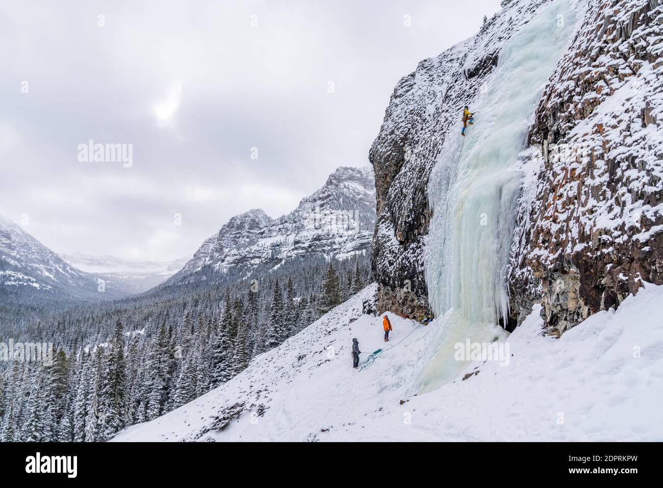 Ice climbers enjoying a day outside climbing frozen waterfalls in ...