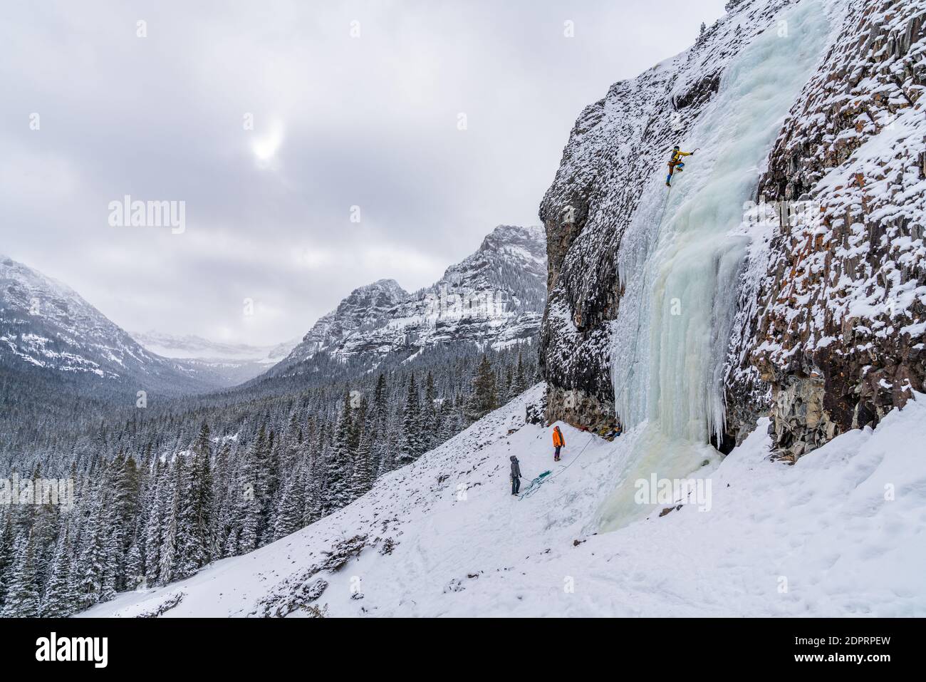 Ice climbers enjoying a day outside climbing frozen waterfalls in ...