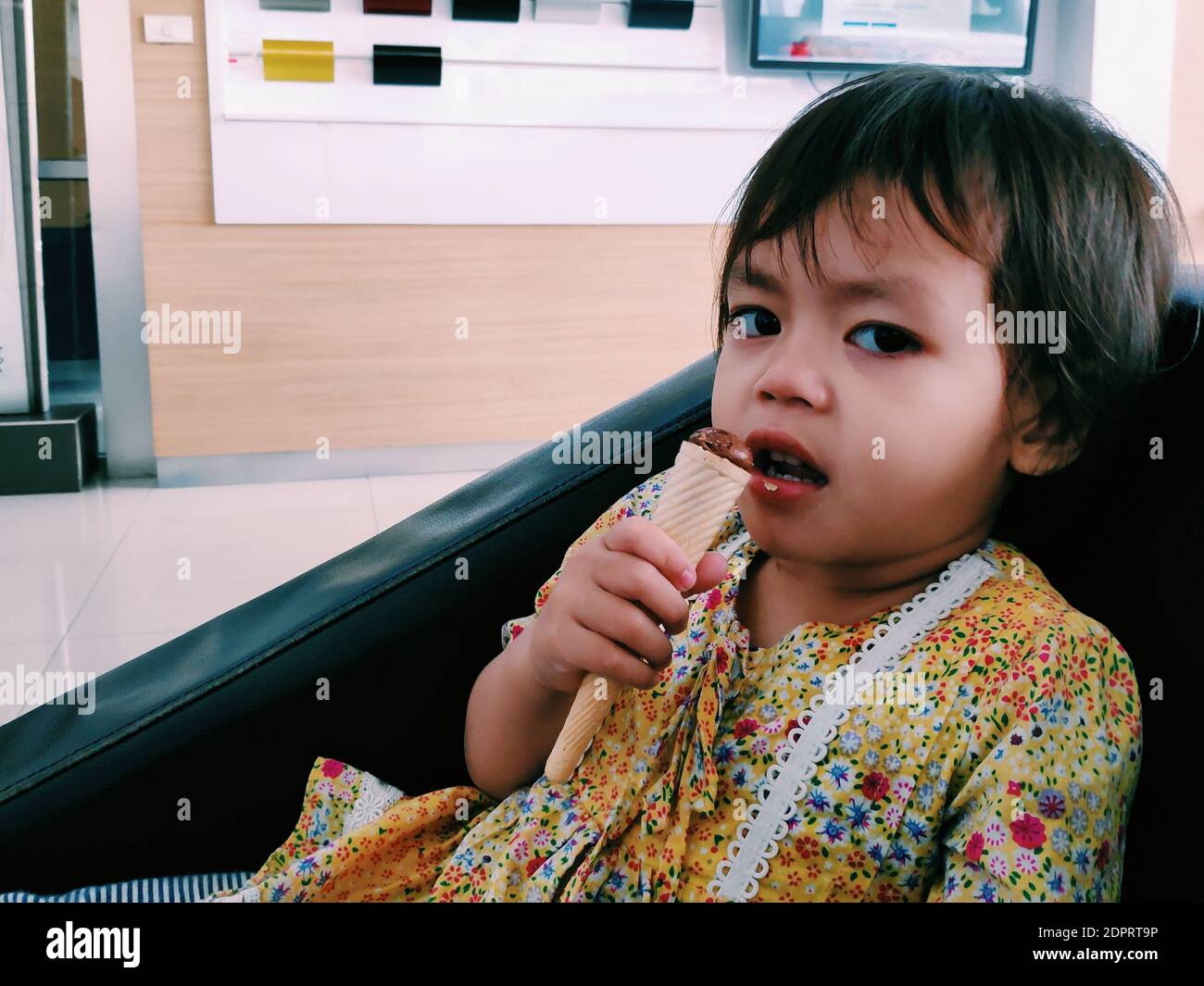 Portrait Of Cute Girl Eating Sweet Food Stock Photo - Alamy