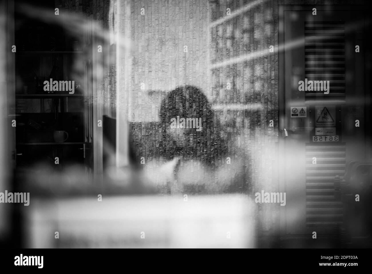 Woman behind window exterior hi-res stock photography and images - Alamy
