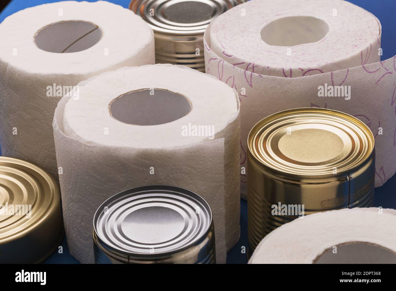 Cans of various canned food and rolls of toilet paper, close-up. Food ...
