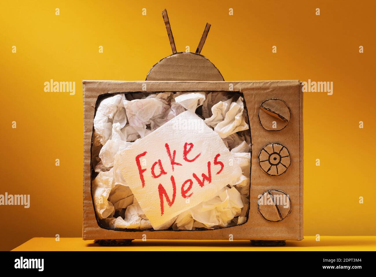 Toy TV with a sheet of toilet paper sticking out of the screen with an ...