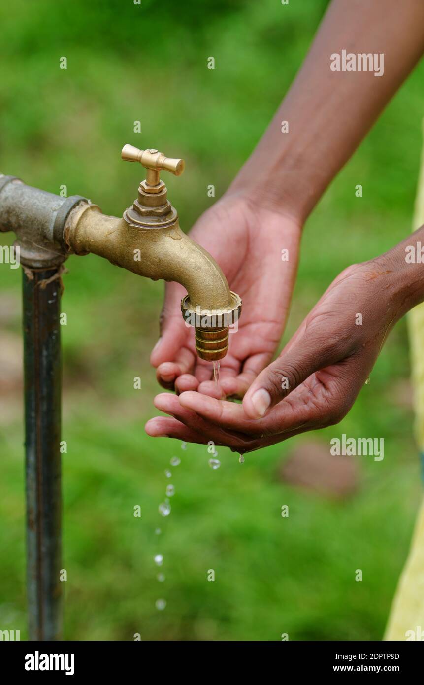 Cupped hands under tap hi-res stock photography and images - Alamy