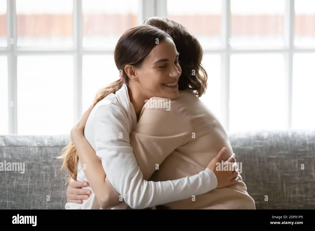 Close up affectionate grownup daughter hugging middle aged mother Stock Photo - Alamy