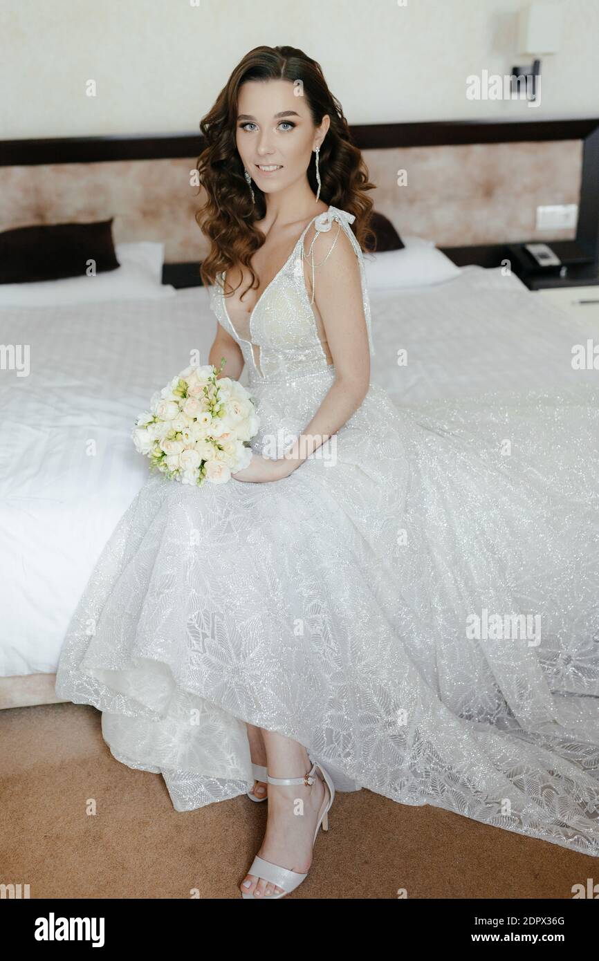 Bride sitting on bed hi-res stock photography and images - Alamy