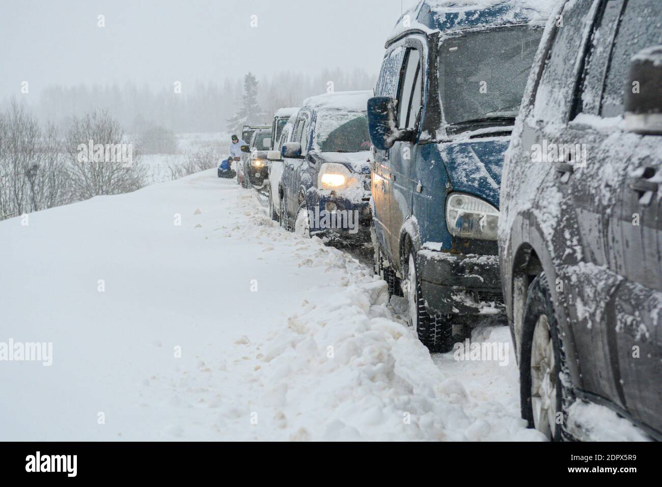 A column of cars stands on a snow-covered road Stock Photo - Alamy