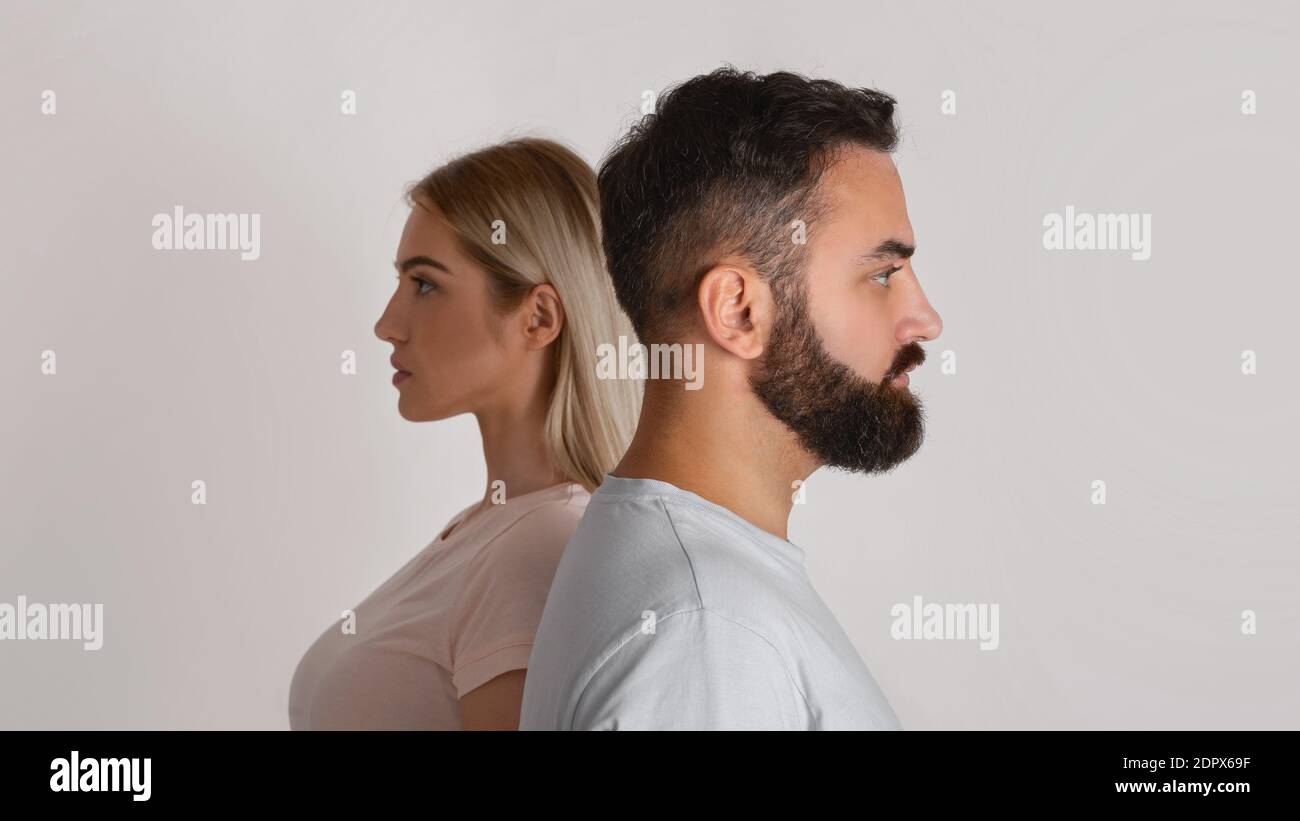 Gender equality and diverging views. Serious man and woman look in ...