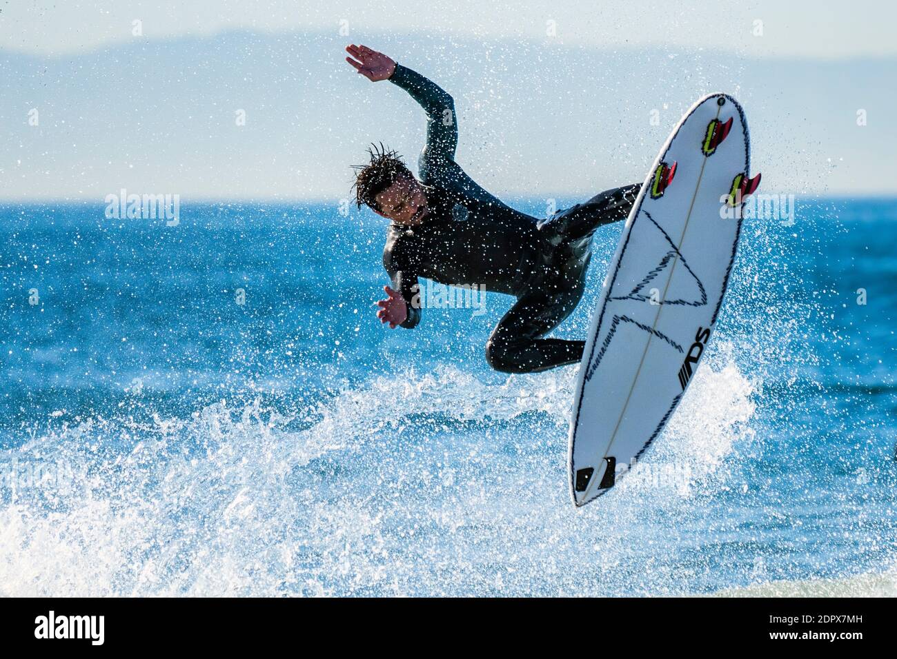 Huntington Beach, United States. 19th Dec, 2020. A surfer rides a wave ...