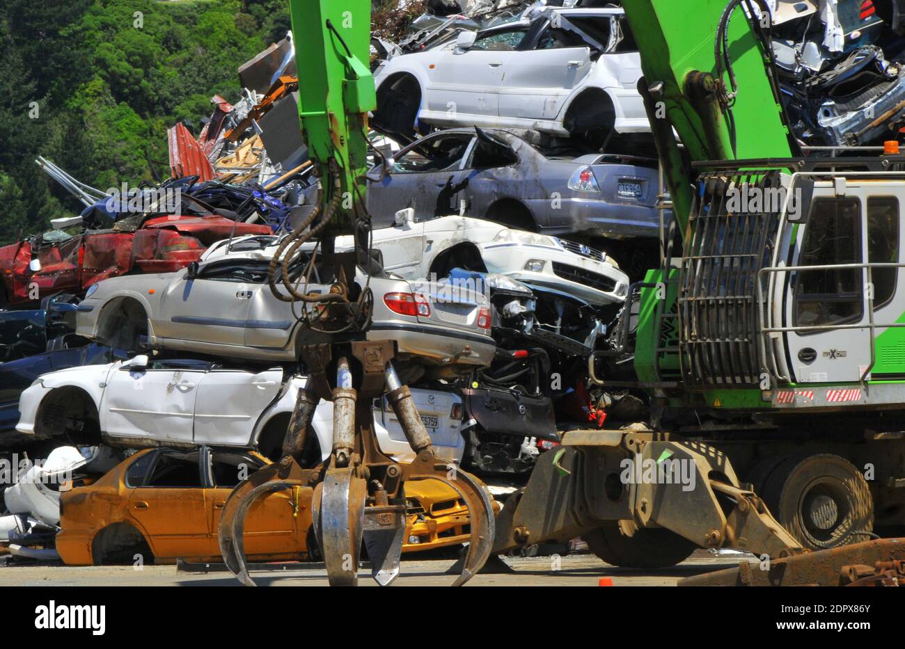 Wrecked cars stacked at metal recycling yard Stock Photo - Alamy