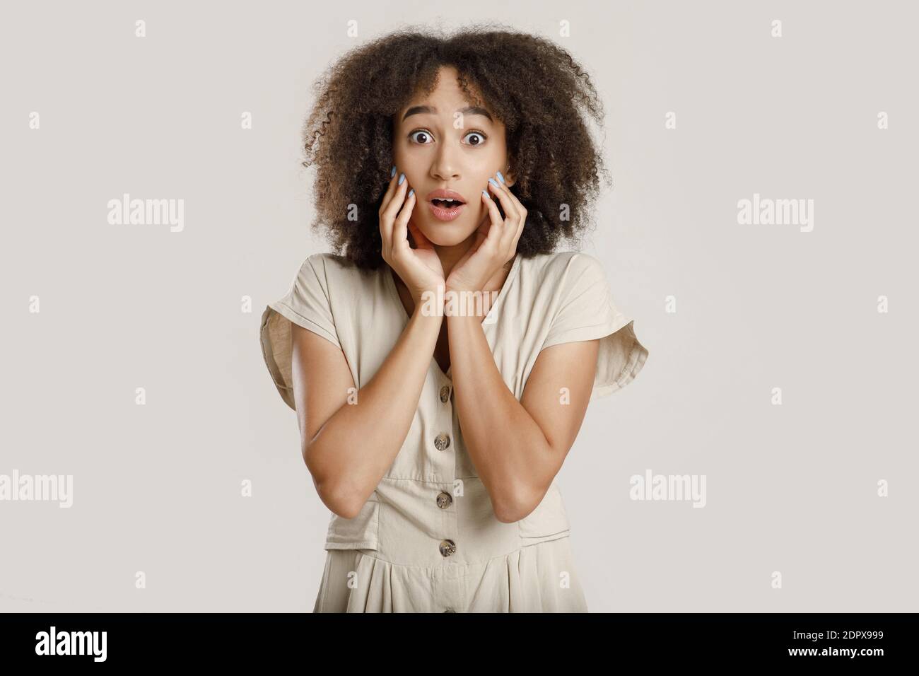 Attractive young woman looks surprisedly and stupefied, facial ...