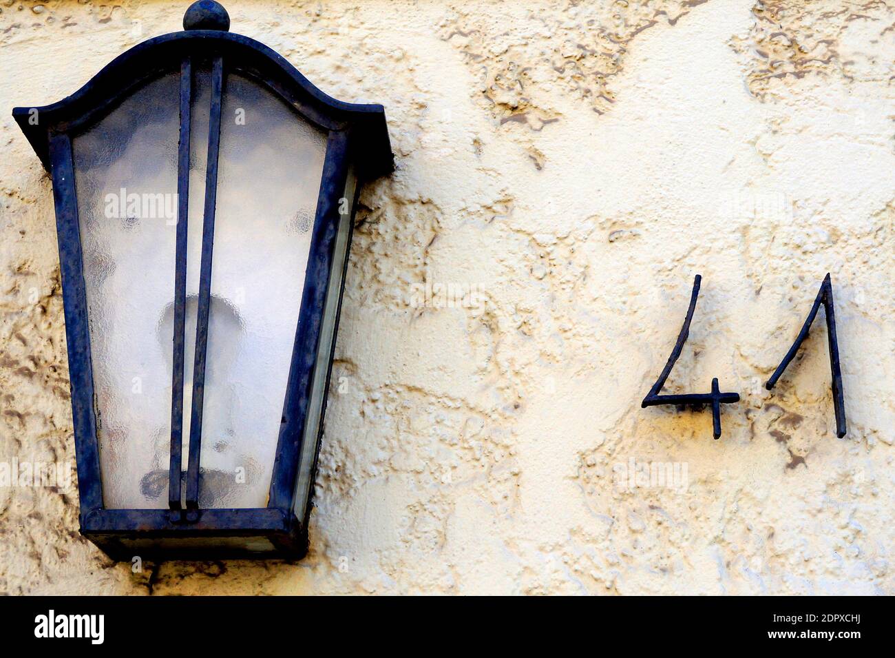A white wall, a blue lantern and house number 41 Stock Photo - Alamy